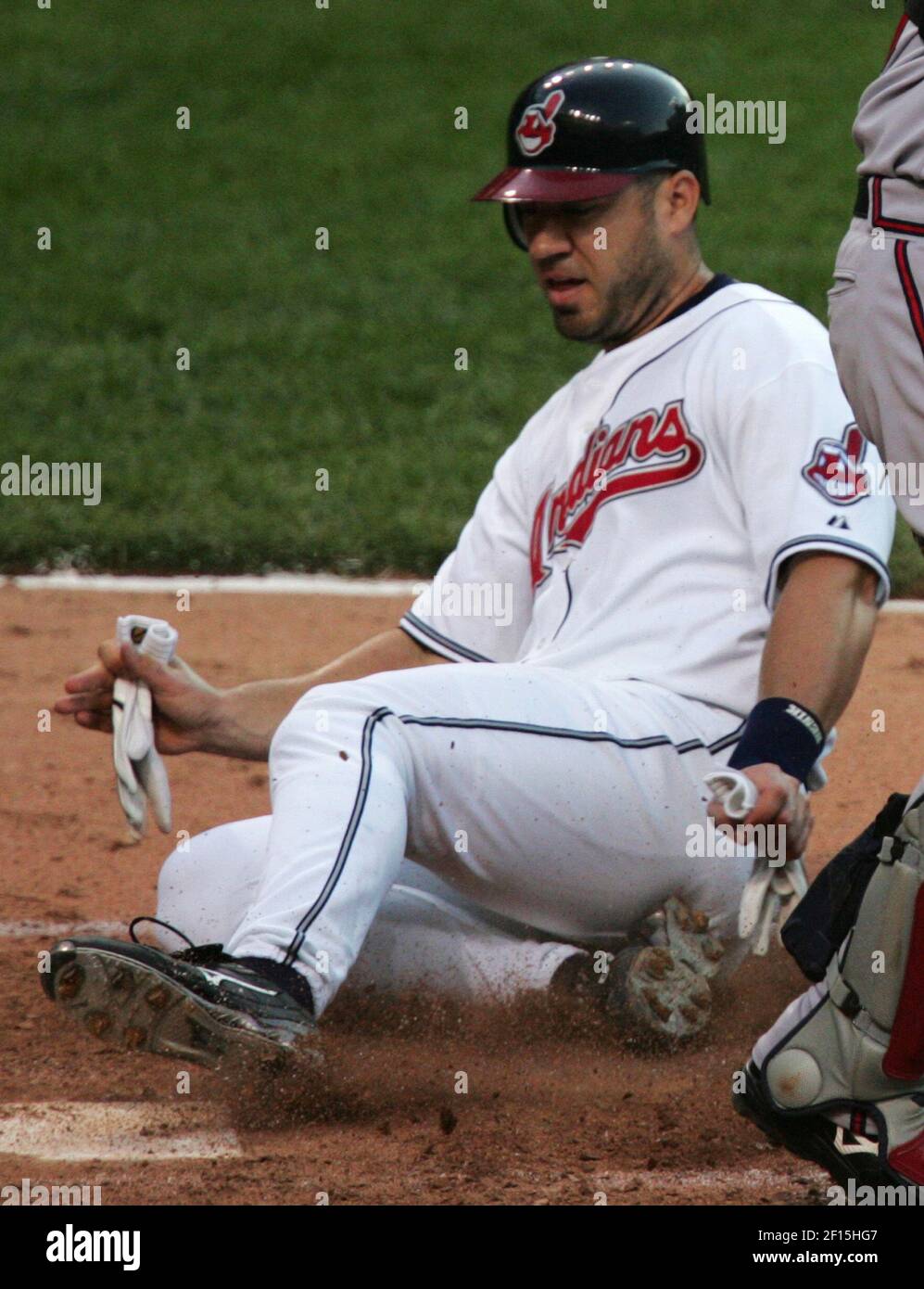The Cleveland Indians' Travis Hafner slides in home safe against the ...