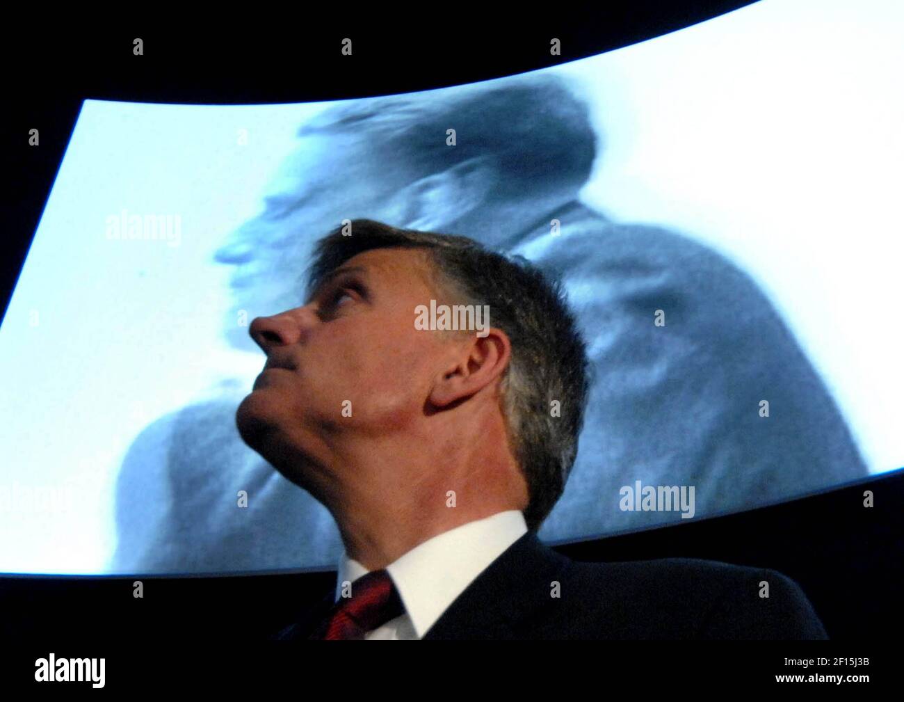 Franklin Graham watches a video of his father during the dedication ...