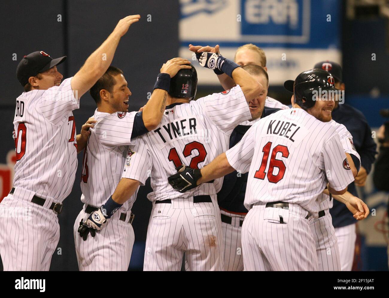 Minnesota Twins Jason Tyner is mobbed at home after scoring with bases ...
