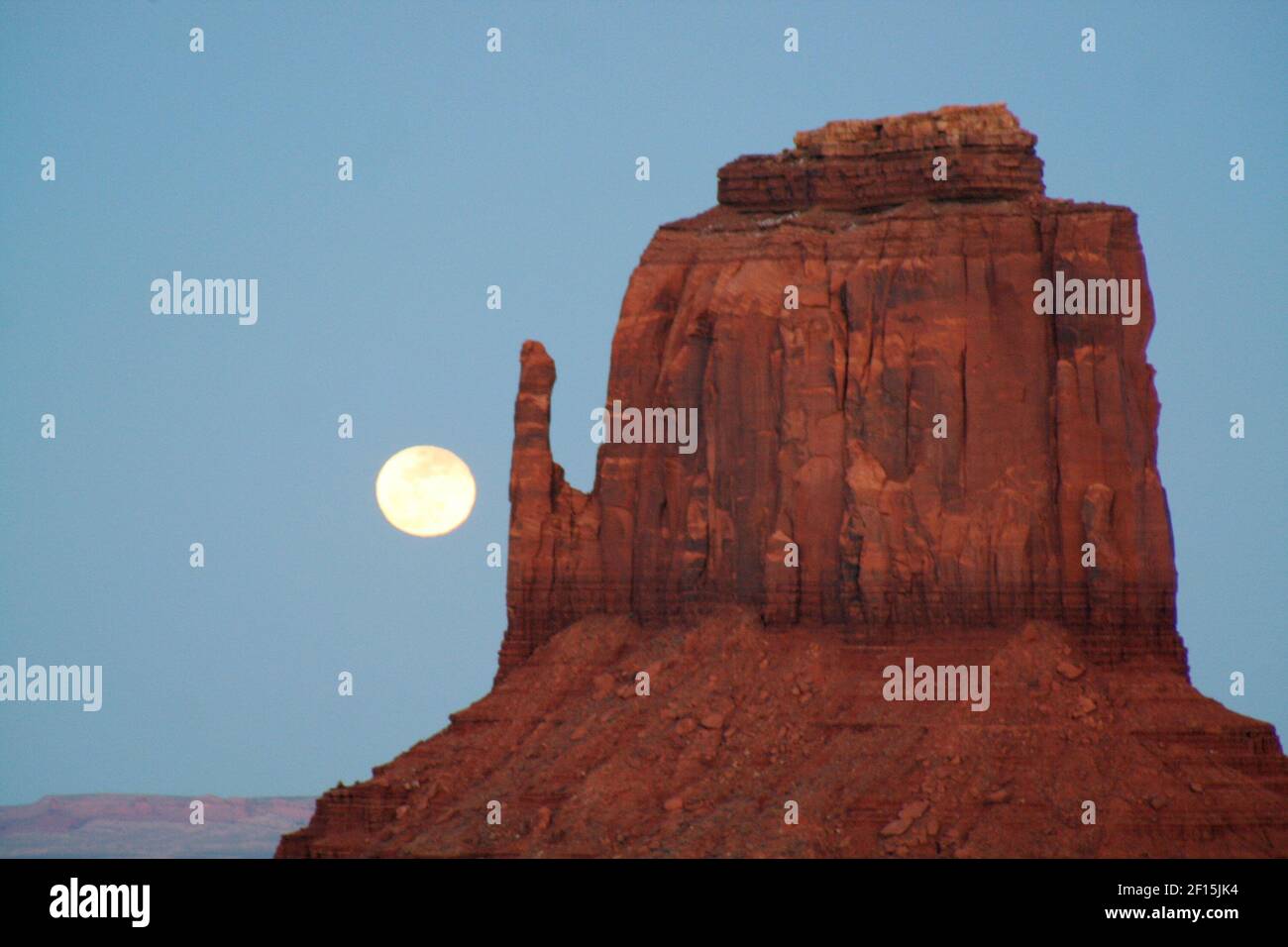A full moon adds drama to the Left Mitten, a Monument Valley formation ...