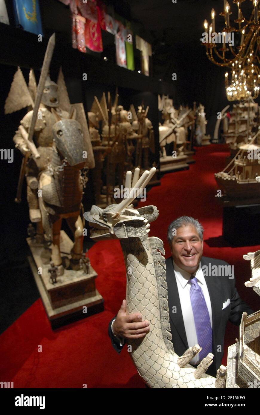 Steven Schussler, founder of Rainforest Cafe, stands with some of the ...