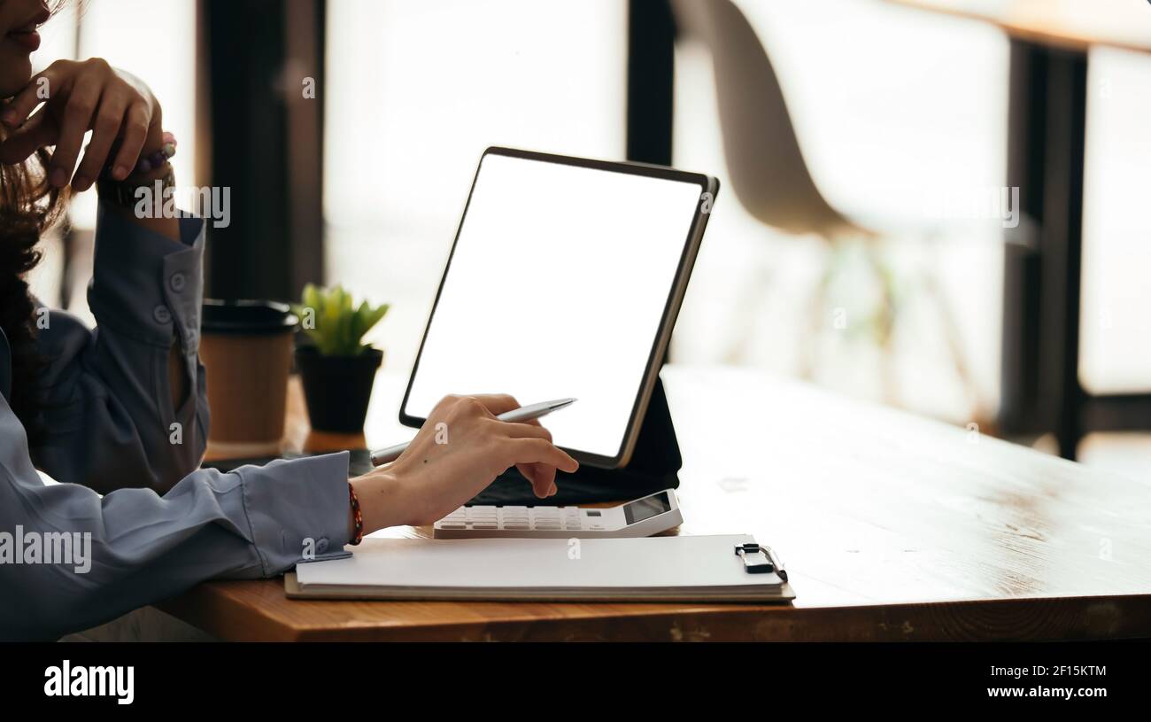 Business woman hand writing on notebook, work on laptop computer with ...