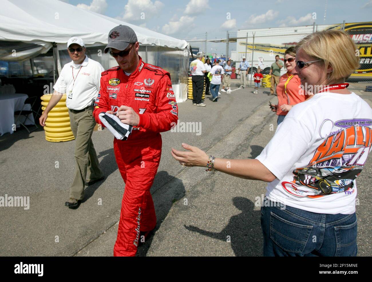 Dale Earnhardt Jr. signs an autograph for Kathy Jennette during Nextel ...