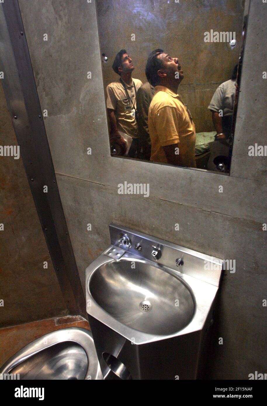 Kurdish visitors, reflected in mirror, involved in Iraq's prison system ...