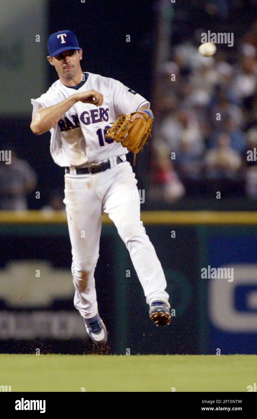 Texas Rangers' Michael Young throws to first for an out in the sixth ...