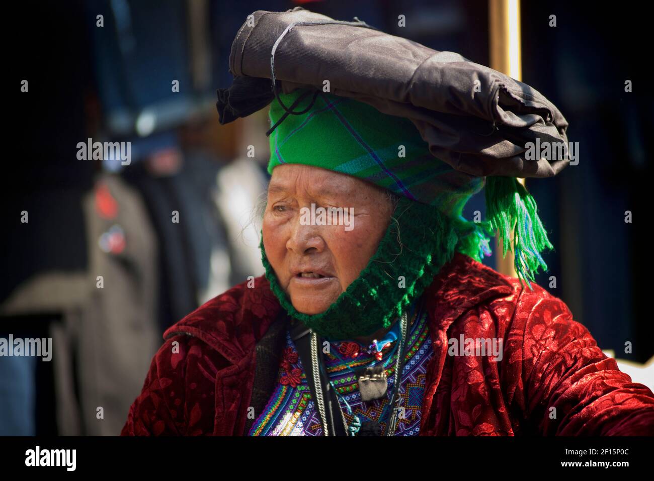 Elderly Flower Hmong woman in tribal attire at market in Can Cau, Lao ...