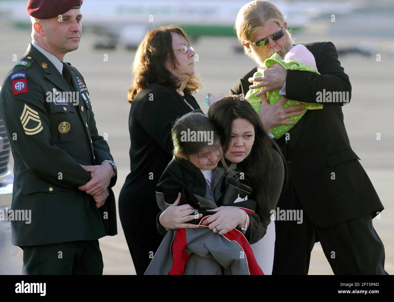 Crystal Becker, foreground right, comforts her daughter, Cierra, 7, as ...