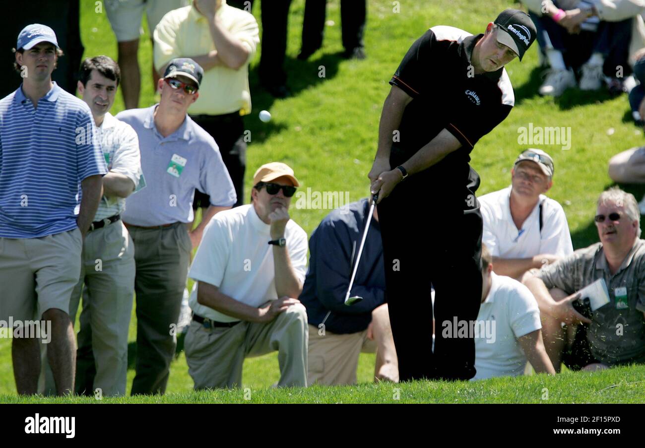 Phil Mickelson makes a chip shot onto the 15th green during the first ...