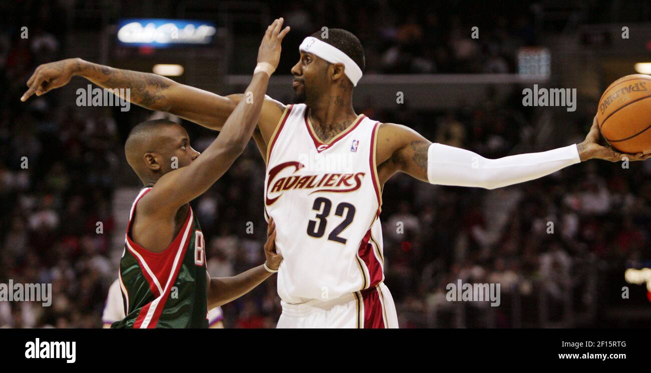 Cleveland Cavaliers' Larry Hughes (right) sets to pass over Milwaukee ...