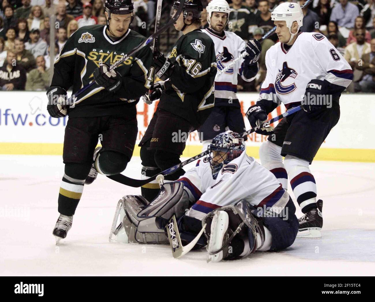 The Vancouver Canucks goalie Robero Luongo covers up the puck in the ...