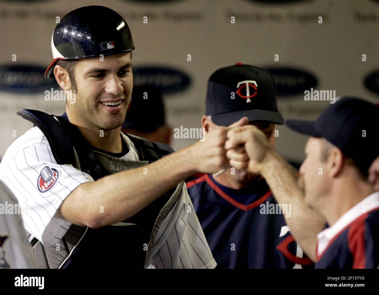 Minnesota Twins' Joe Mauer is congratulated by teammates after Mauer ...