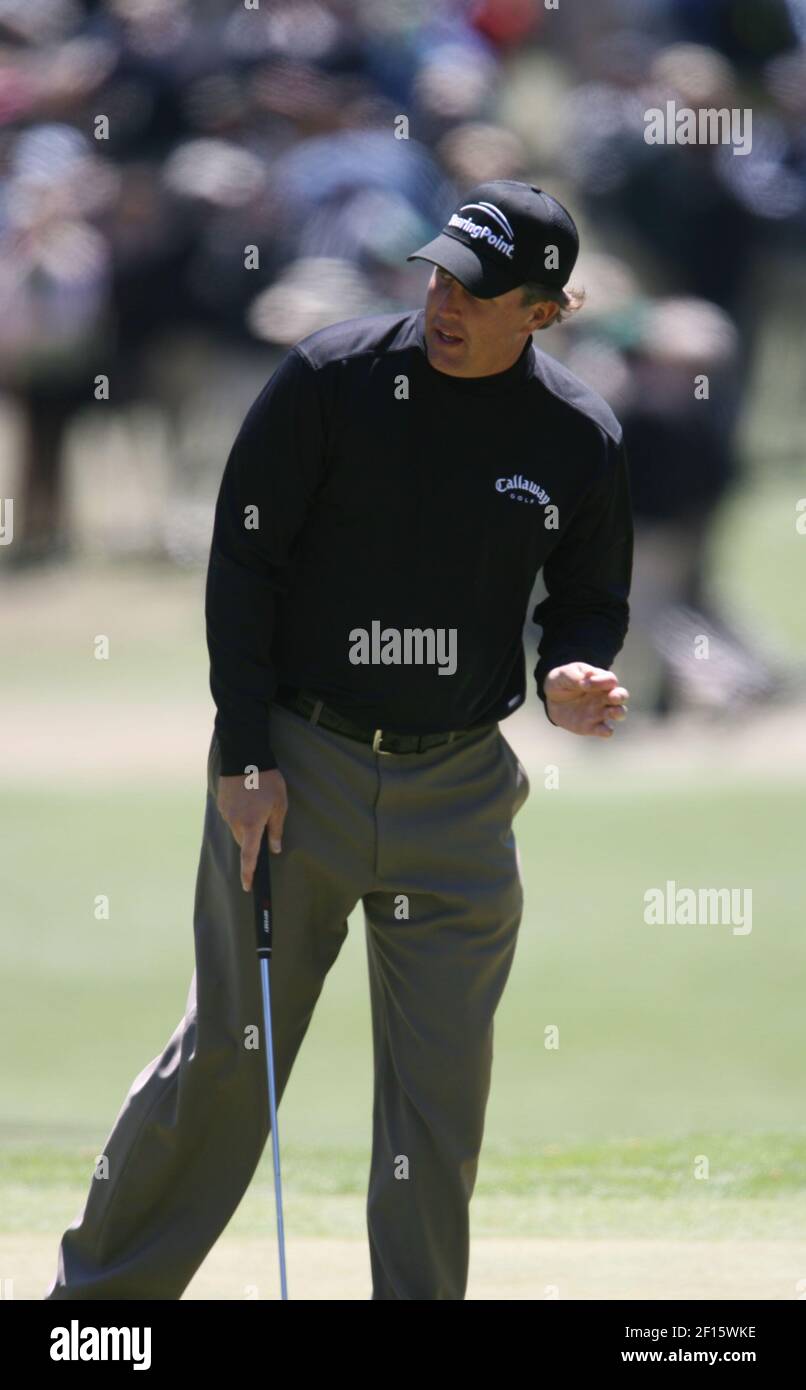 Phil Mickelson uses a little body language to coach a putt on the sixth ...