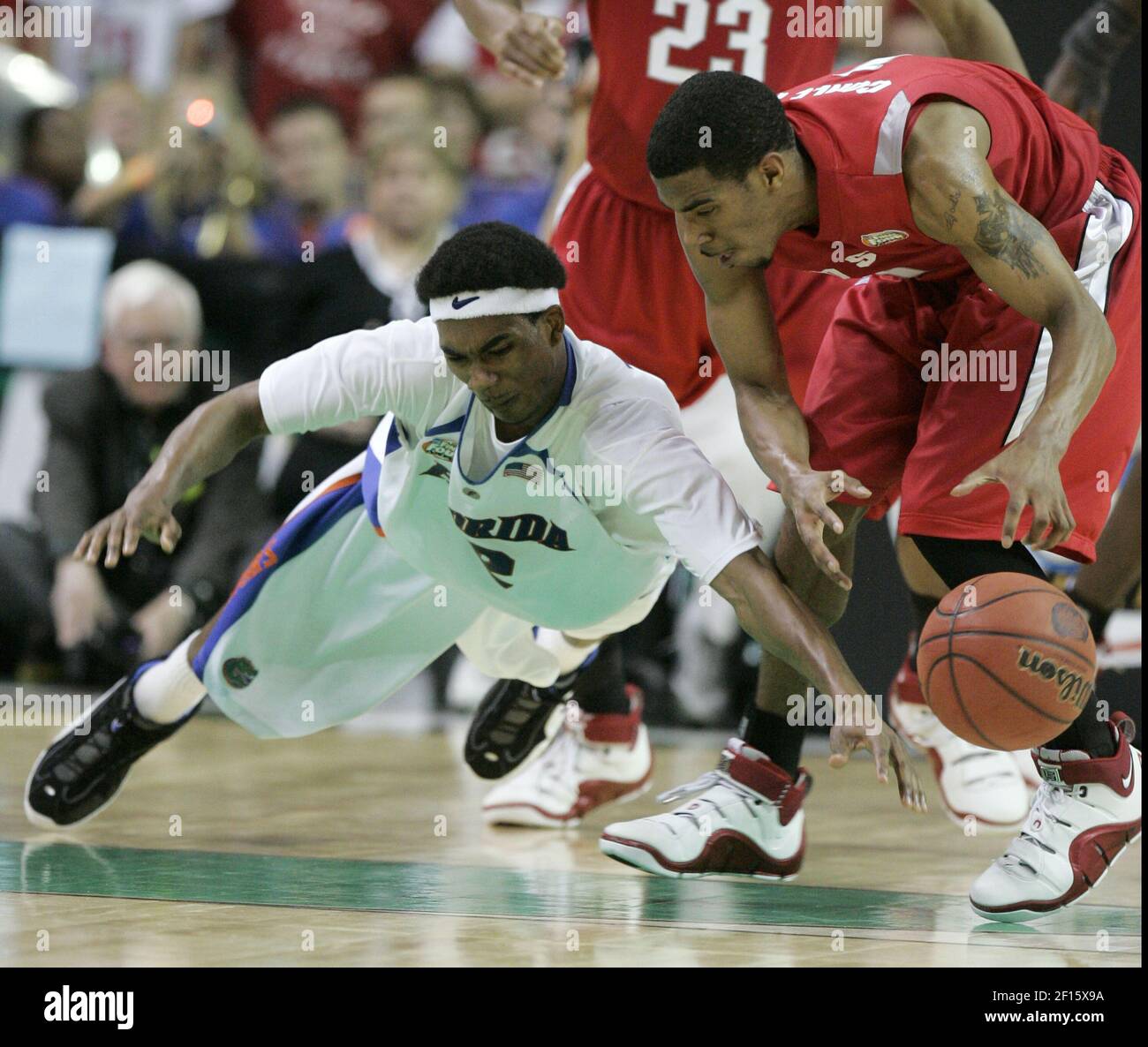 Florida's Corey Brewer and Ohio State's Mike Conley Jr. vie for a loose ...