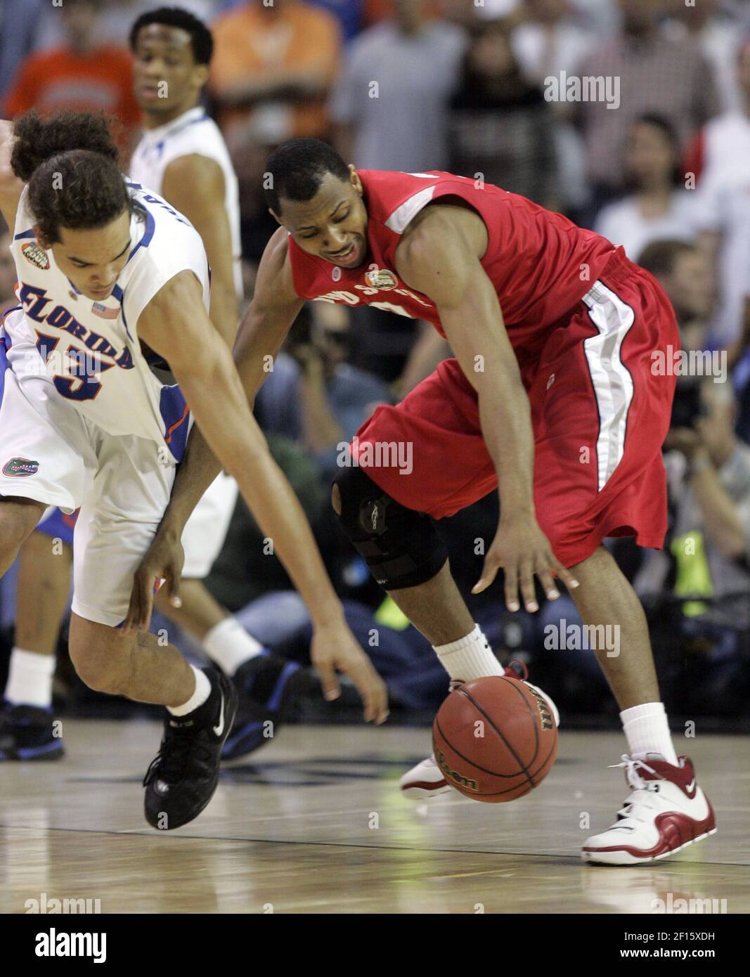 Florida's Joakim Noah and Ohio State's Ivan Harris vie for a loose ball ...
