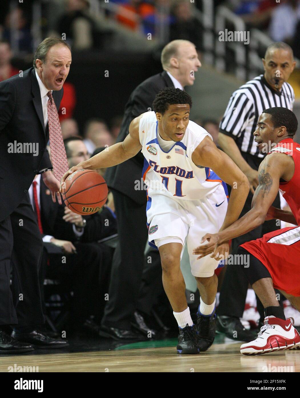 Florida's Taurean Green dribbles past the Ohio state bench during the ...