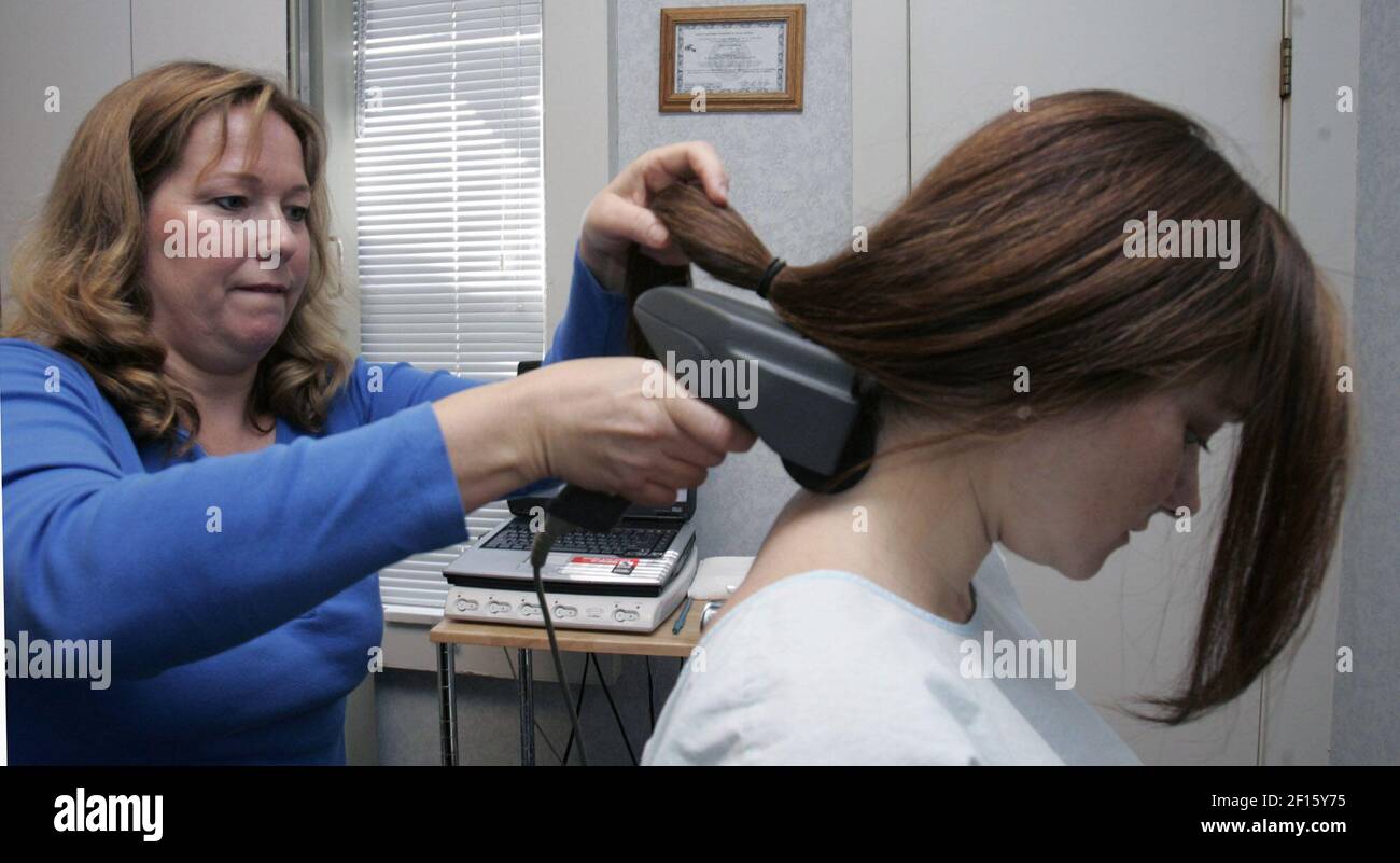 Chiropractor Anne Lundquist demonstrates surface electromyography and ...