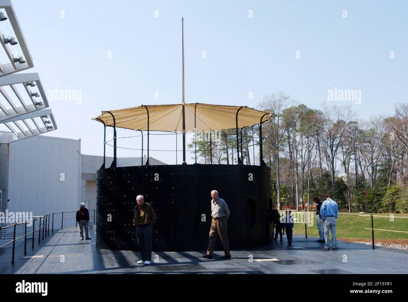 Visitors stroll the deck of a full-size reproduction of the USS Monitor ...