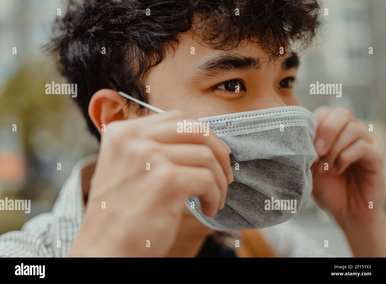 close up face of young asian man wearing medical mask. Selective focus ...