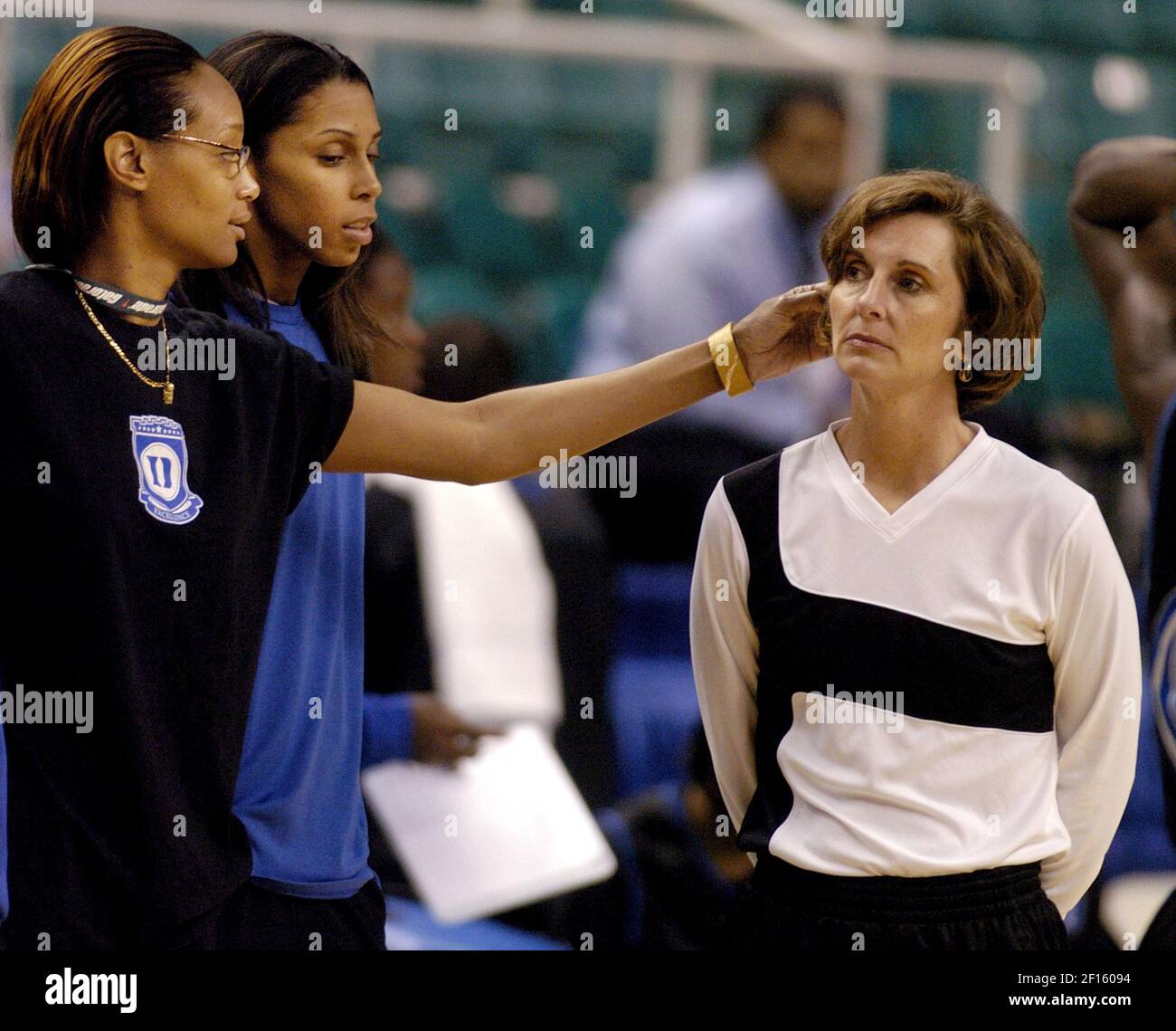 Duke head coach Gail Goestenkors (right) gets her hair fixed by ...