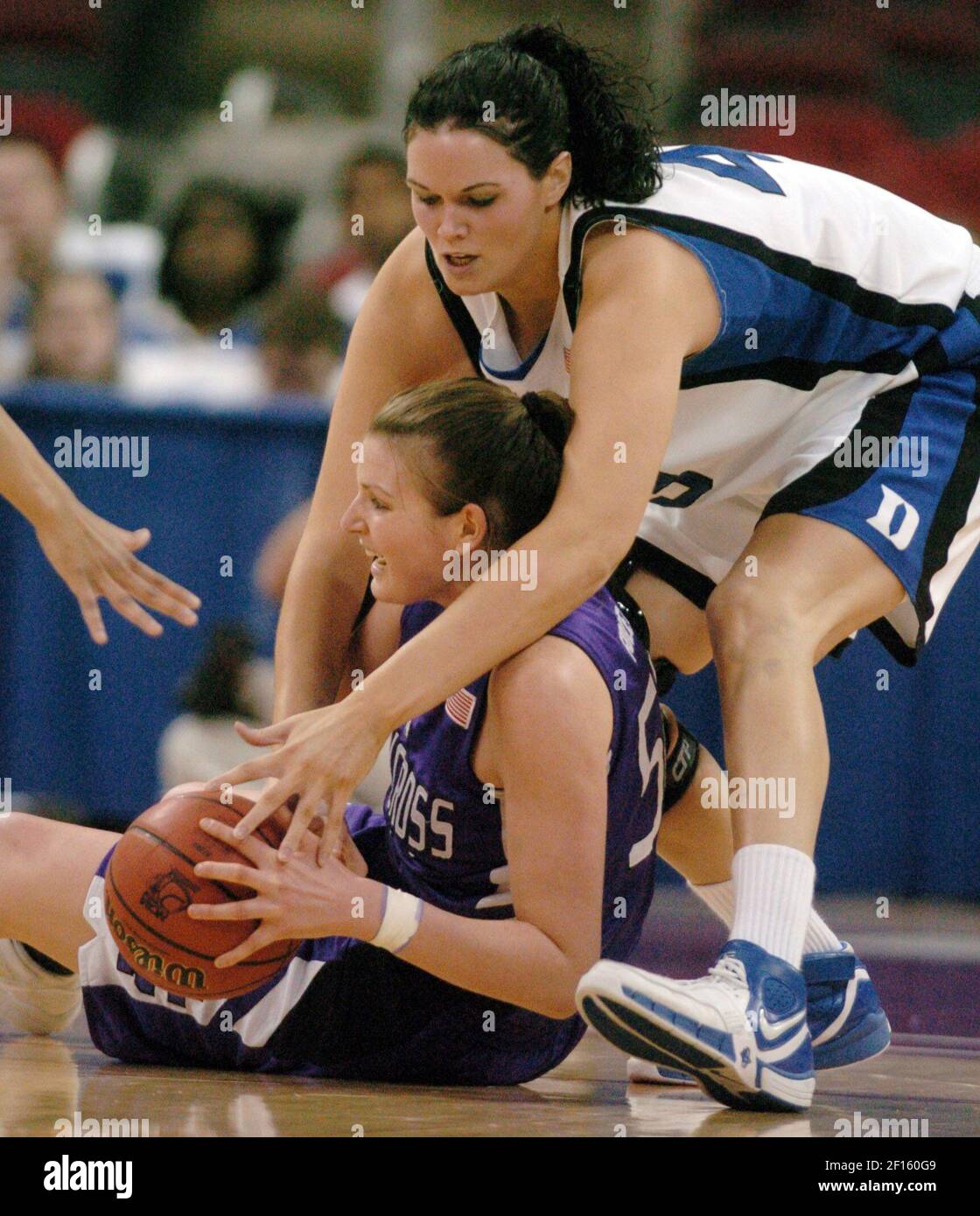 Duke's Alison Bales wrestles with Holy Cross's Kaitlin Foley during ...