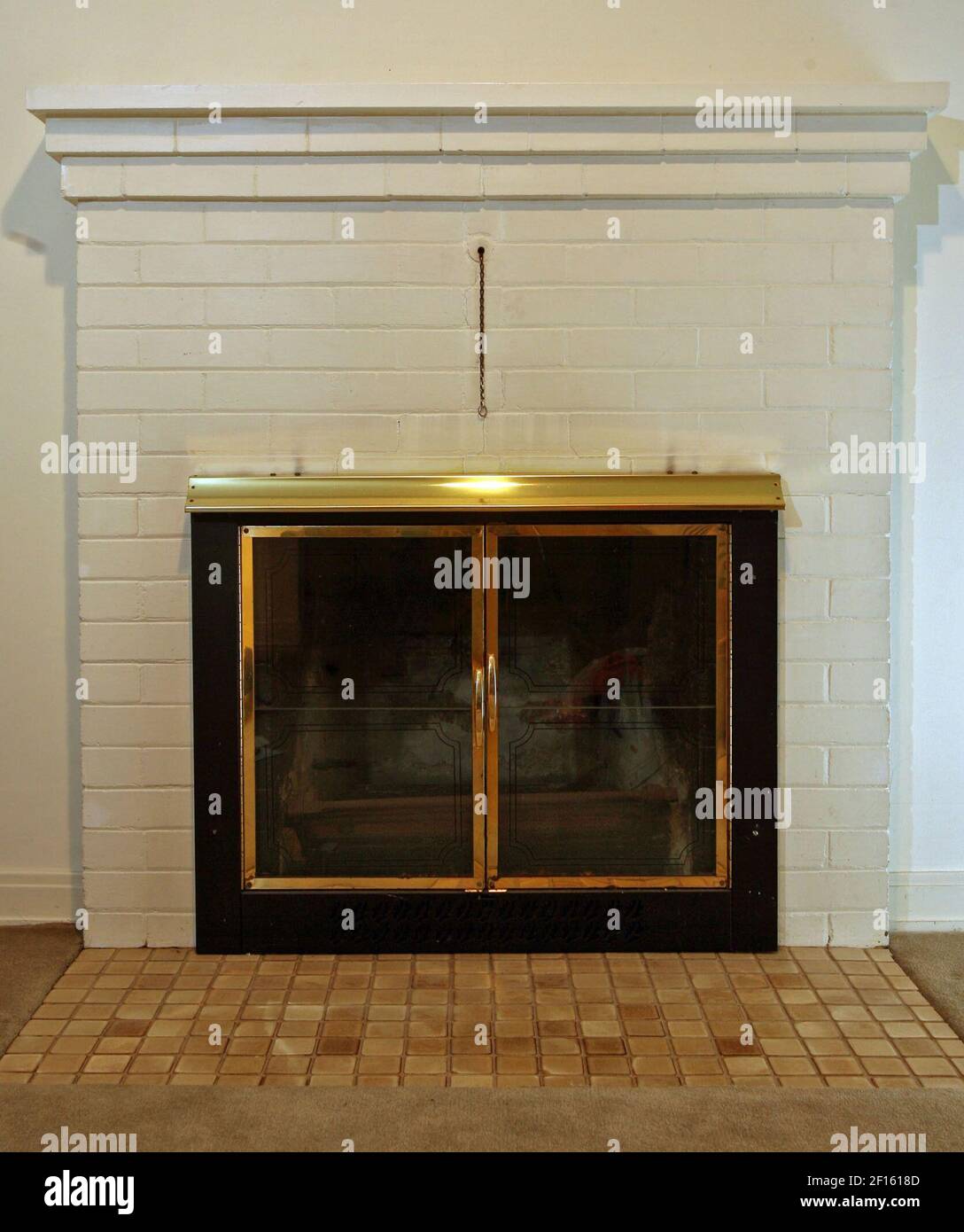 This drab fireplace is shown before being tranformed with the trompe l ...