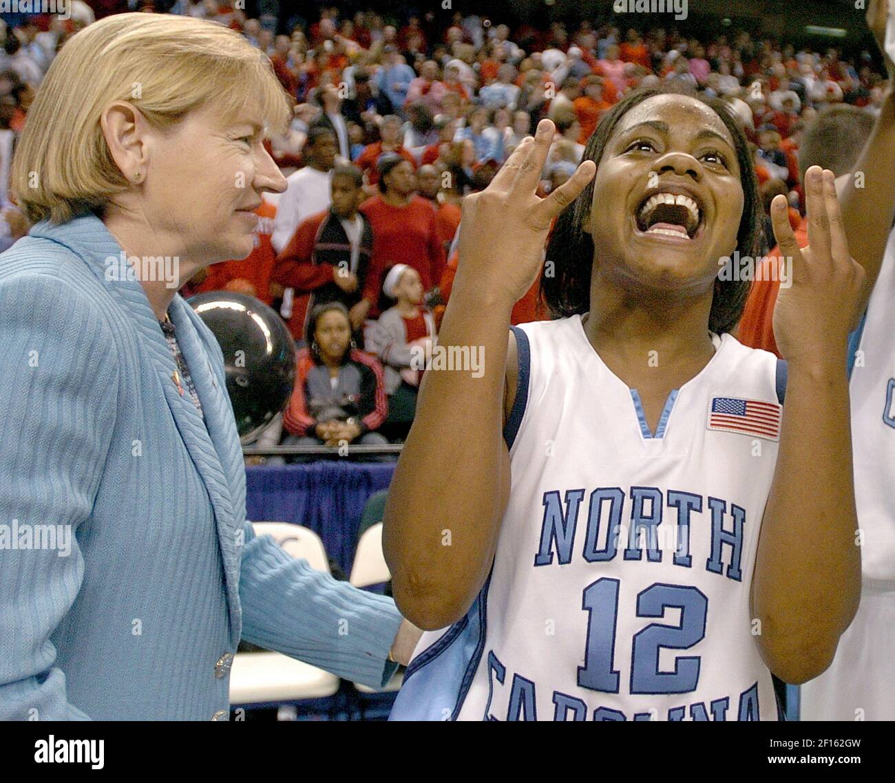 North Carolina head coach Sylvia Hatchell looks on as Ivory Latta holds ...