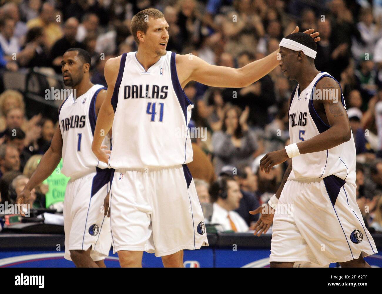 Dallas Mavericks' Dirk Nowitzki gives teammate, Josh Howard, a pat on ...