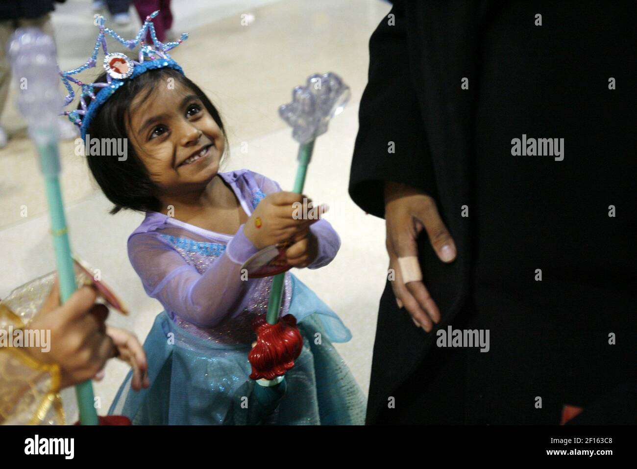Aisha Papa, 3, of Hoffman Estates examines her new wand at the Disney ...