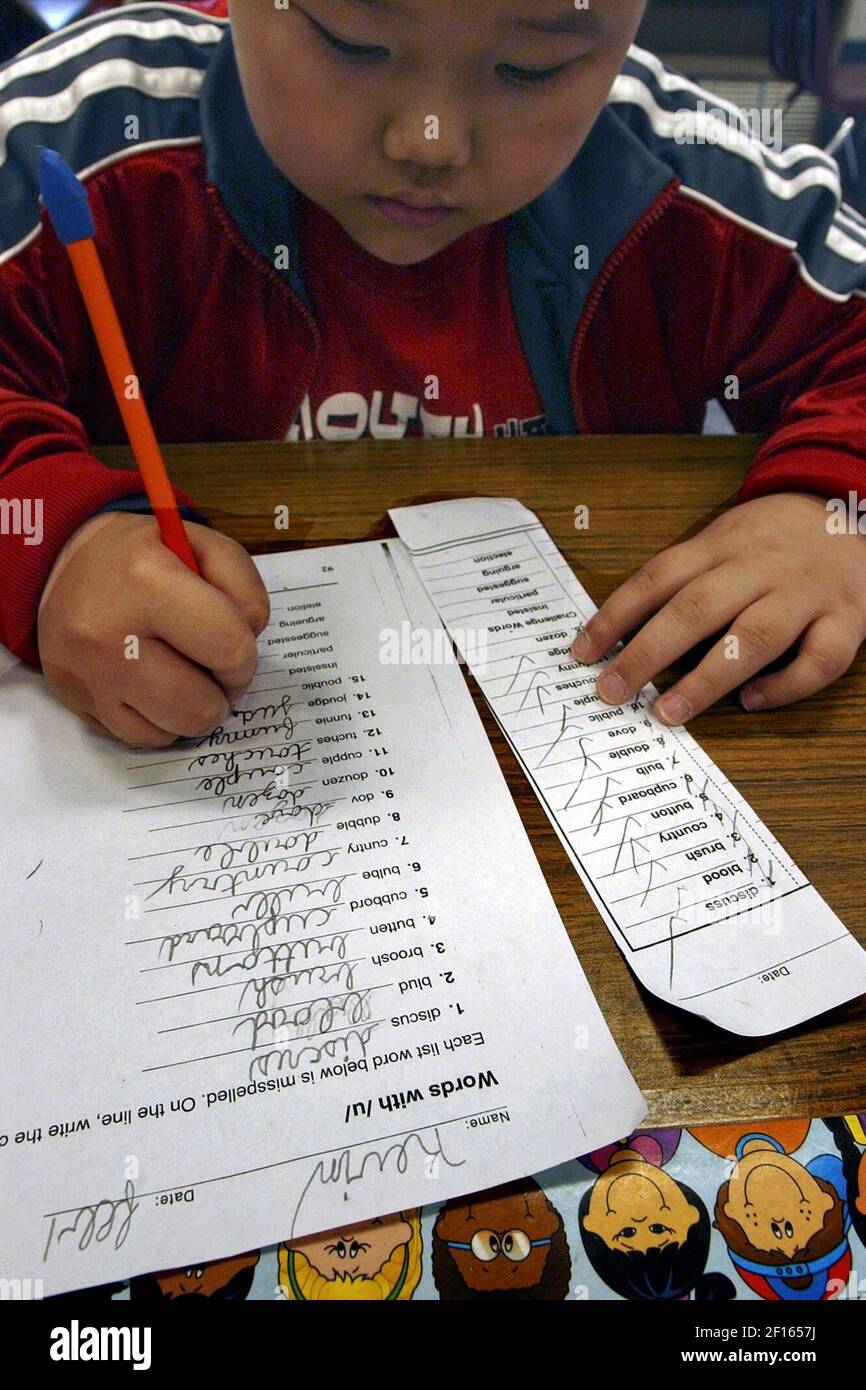 Horace Mann School third grader Kevin Yang uses cursive writing to ...