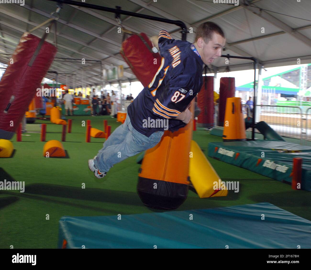 Barry Trilla dives through tackling dummies at the NFL Experience ...