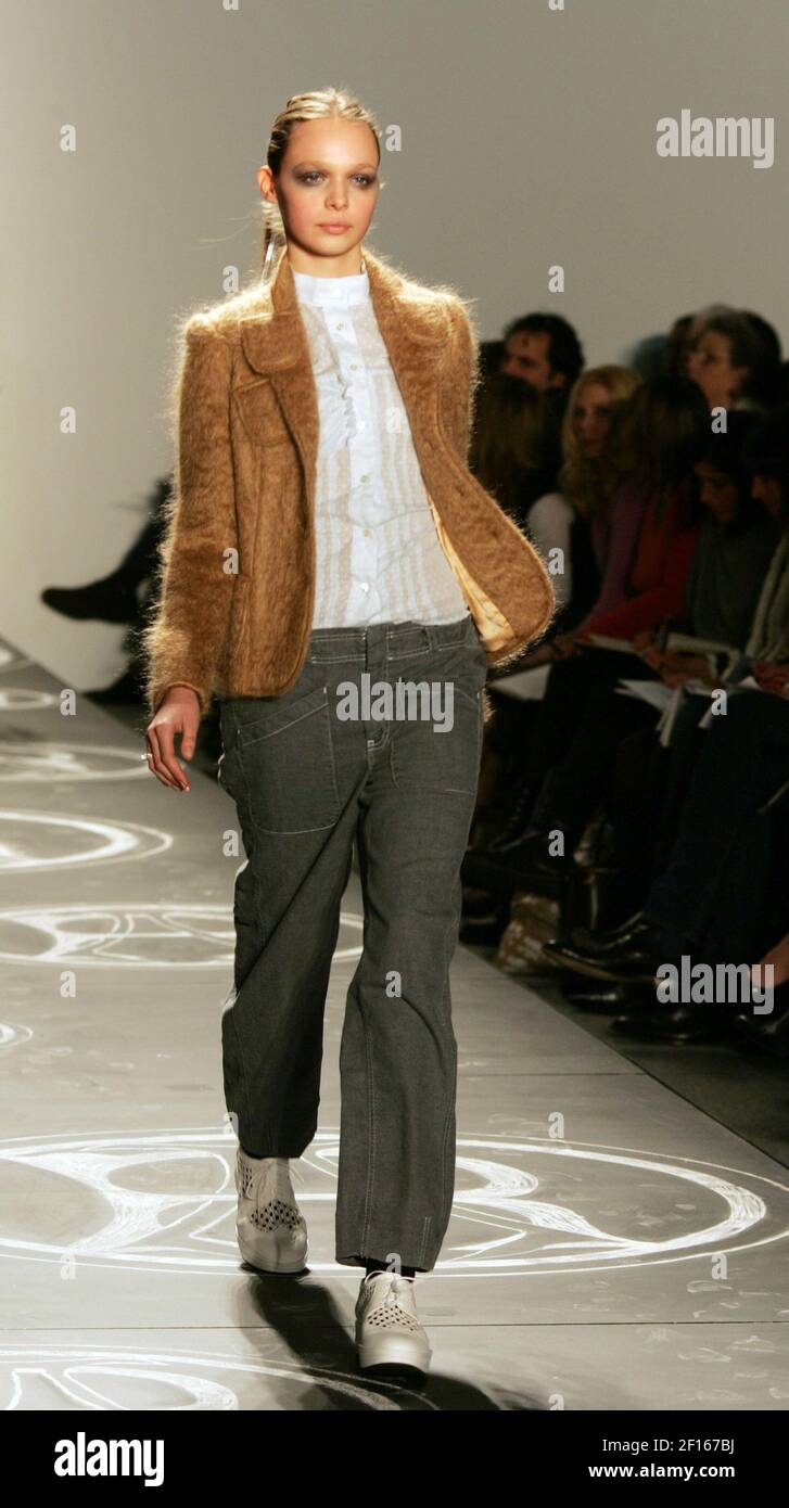 A model wears a two-pock caramel tizzy jacket over swiss dot infirm ...