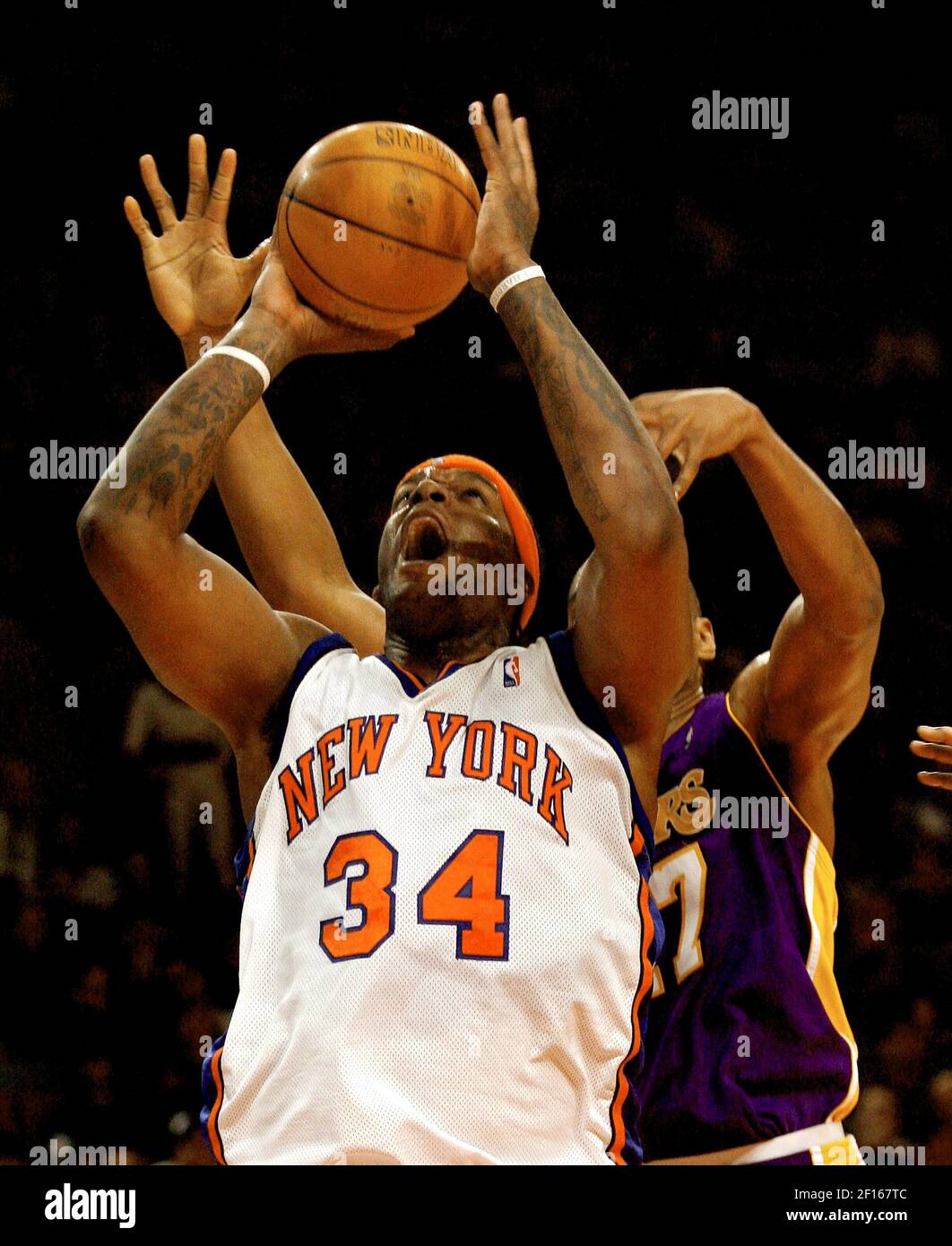 Los Angeles Lakers' Andrew Bynum fouls New York Knicks' Eddy Curry from ...