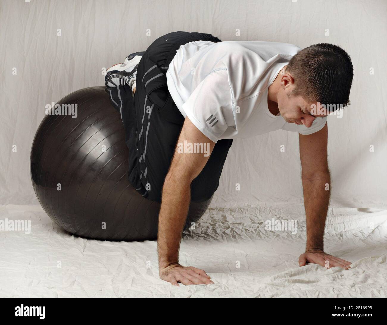 Michael Duck demonstrates a back-stengthening, prone knee exercise ...