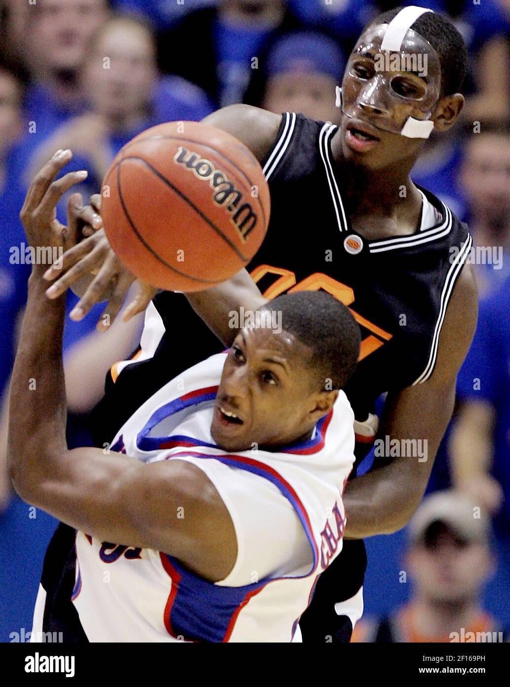 Kansas guard Mario Chalmers fights for possession with Oklahoma State's ...