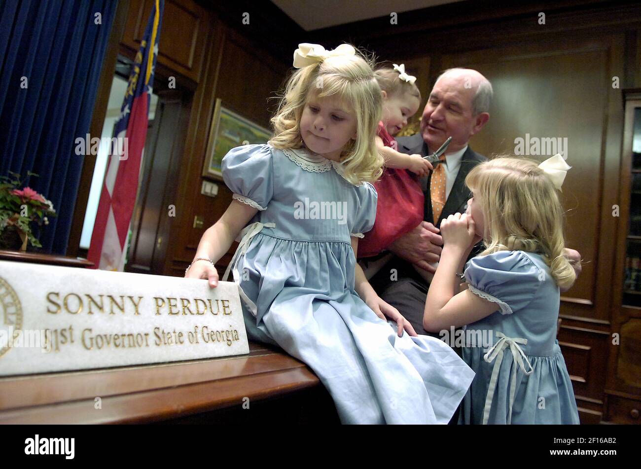 Georgia Gov. Sonny Perdue is entertained by his granddaughters ...