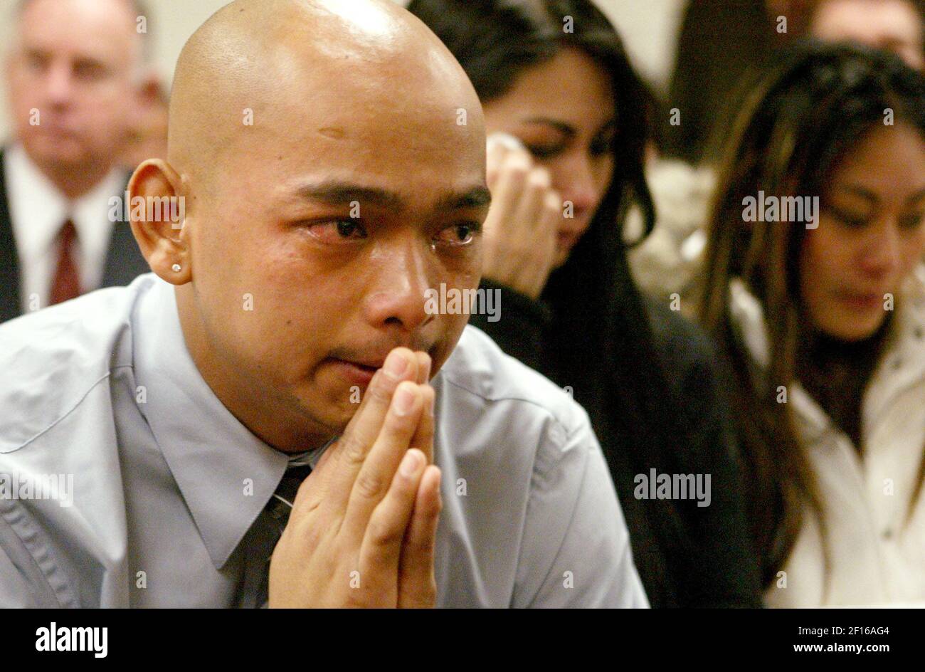 Rith Kok, brother of shooting victim, Samnang Kok, listens as Douglas ...