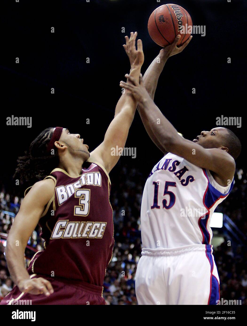 Kansas' Mario Chalmers (15) pushes the hand of Boston College's Jared ...