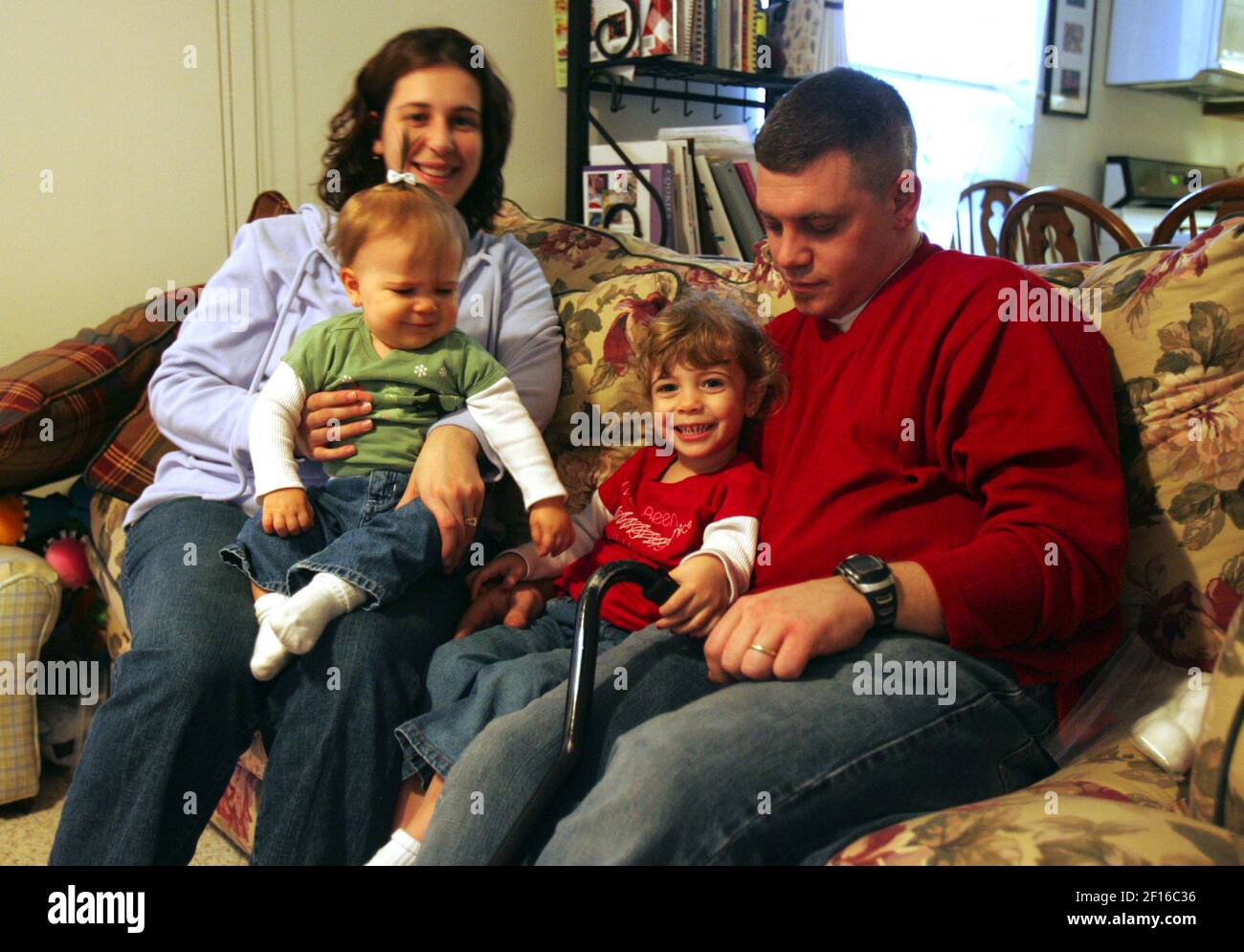Retired U.S. Air Force Sgt. David Lyles sits with his family, Stacy ...