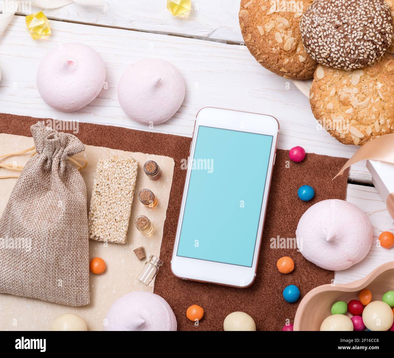 Mock-up of smartphone among sweets Stock Photo - Alamy