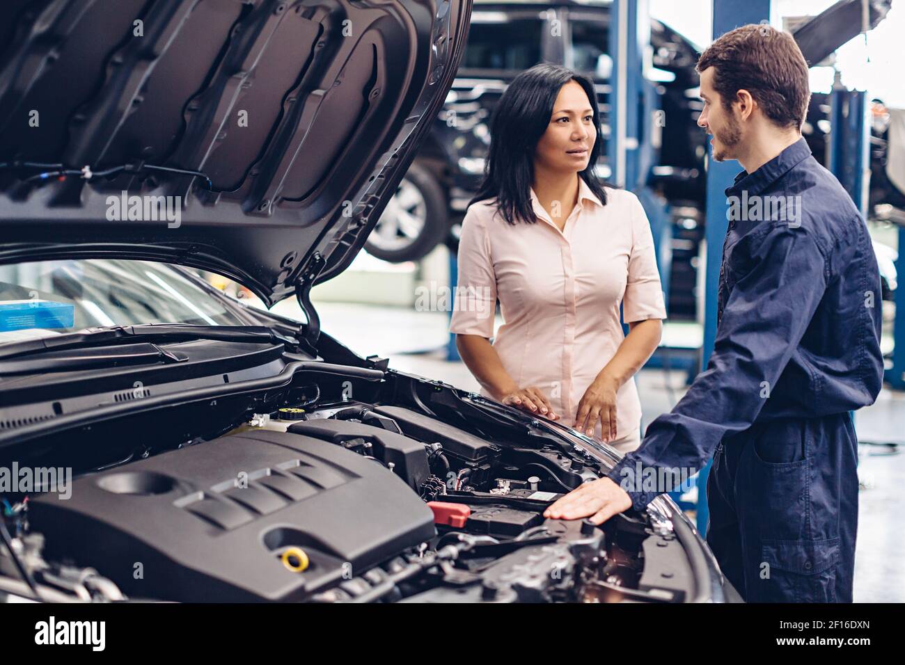 Auto mechanic talking hi-res stock photography and images - Alamy
