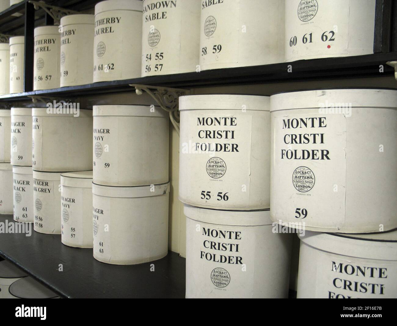 Boxes containing some of the many hat styles for men line the shelves ...