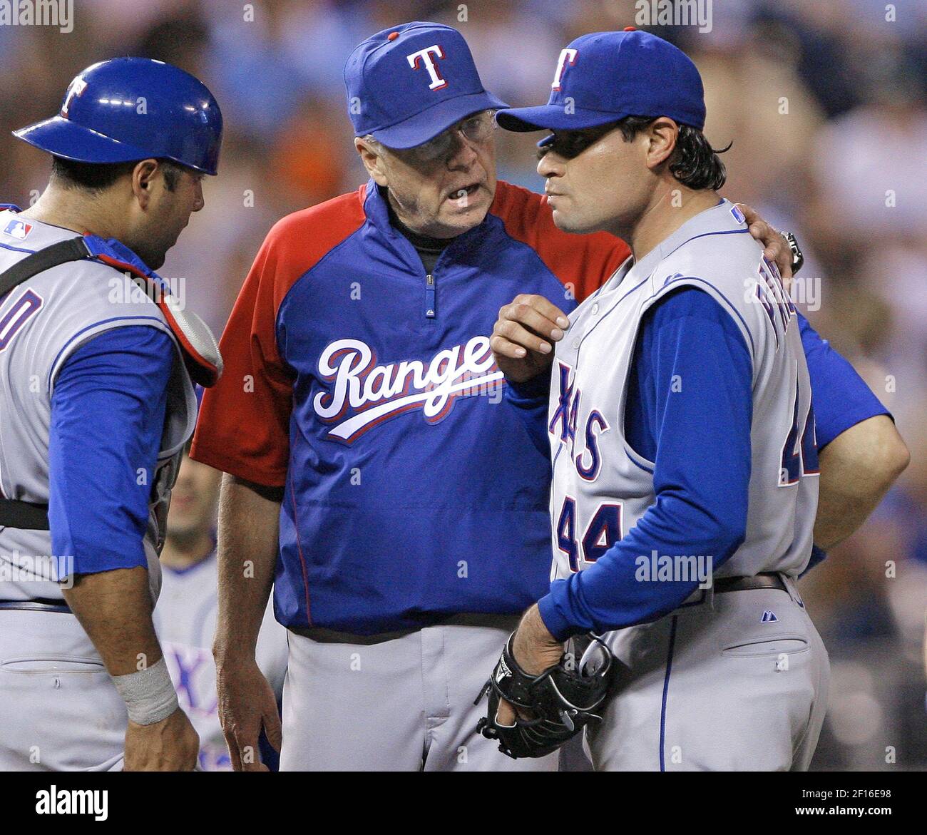 Texas Rangers pitching coach Mark Connor (center) makes a visit to the ...