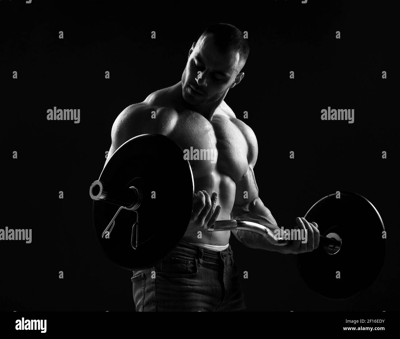 Muscular strong men, athlete, bodybuilder, weightlifter does exercises ...