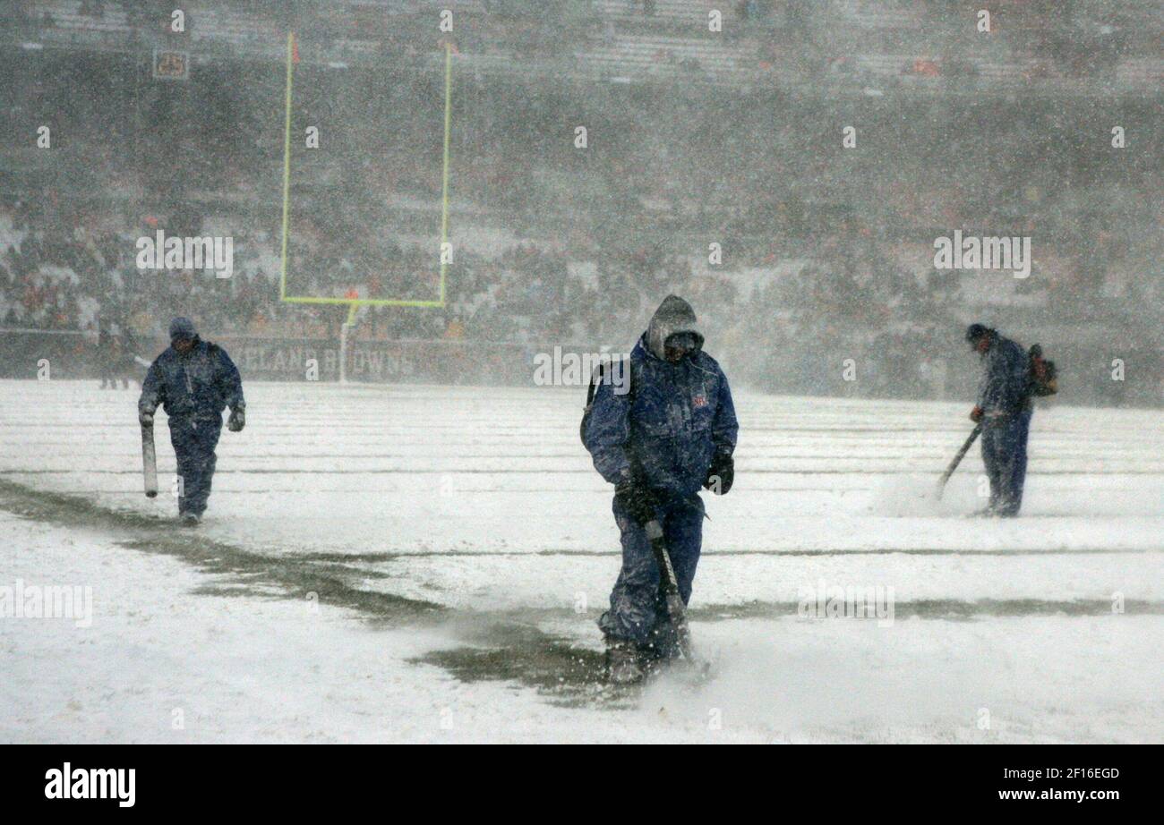 The grounds crew at Cleveland Browns stadium clear the yard markers ...