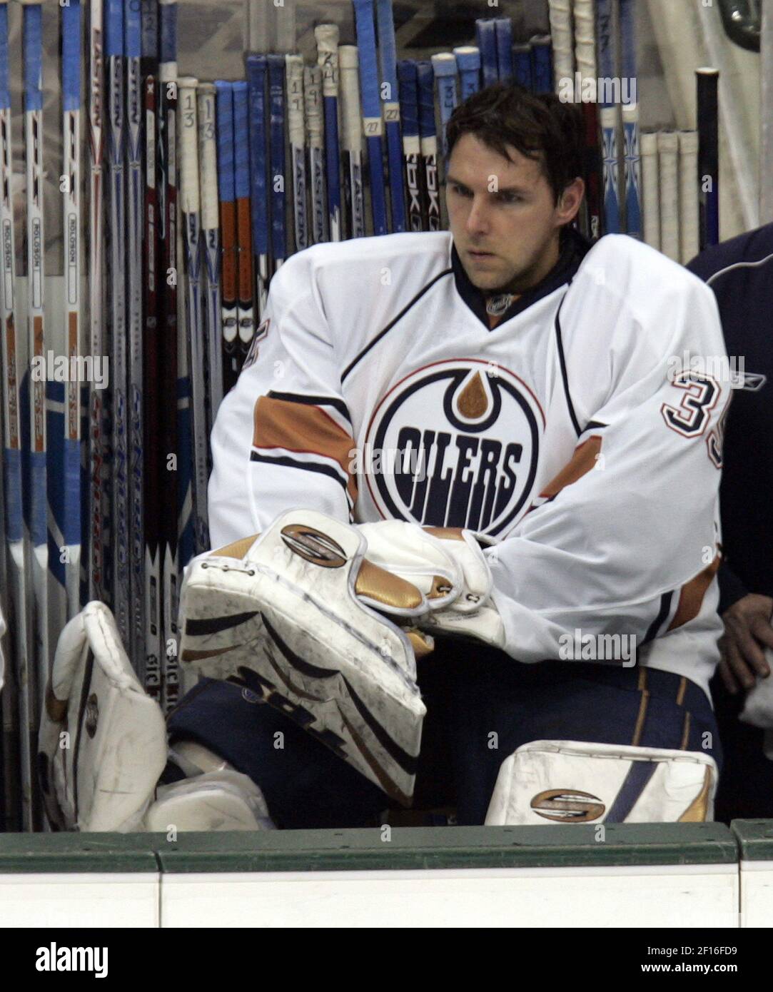 Edmonton Oilers goalie Dwayne Roloson sits on the bench after being ...
