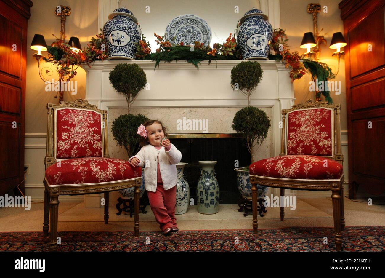 Riley Bell, 18 months, stands in front of grandmother Kathy Boone's ...
