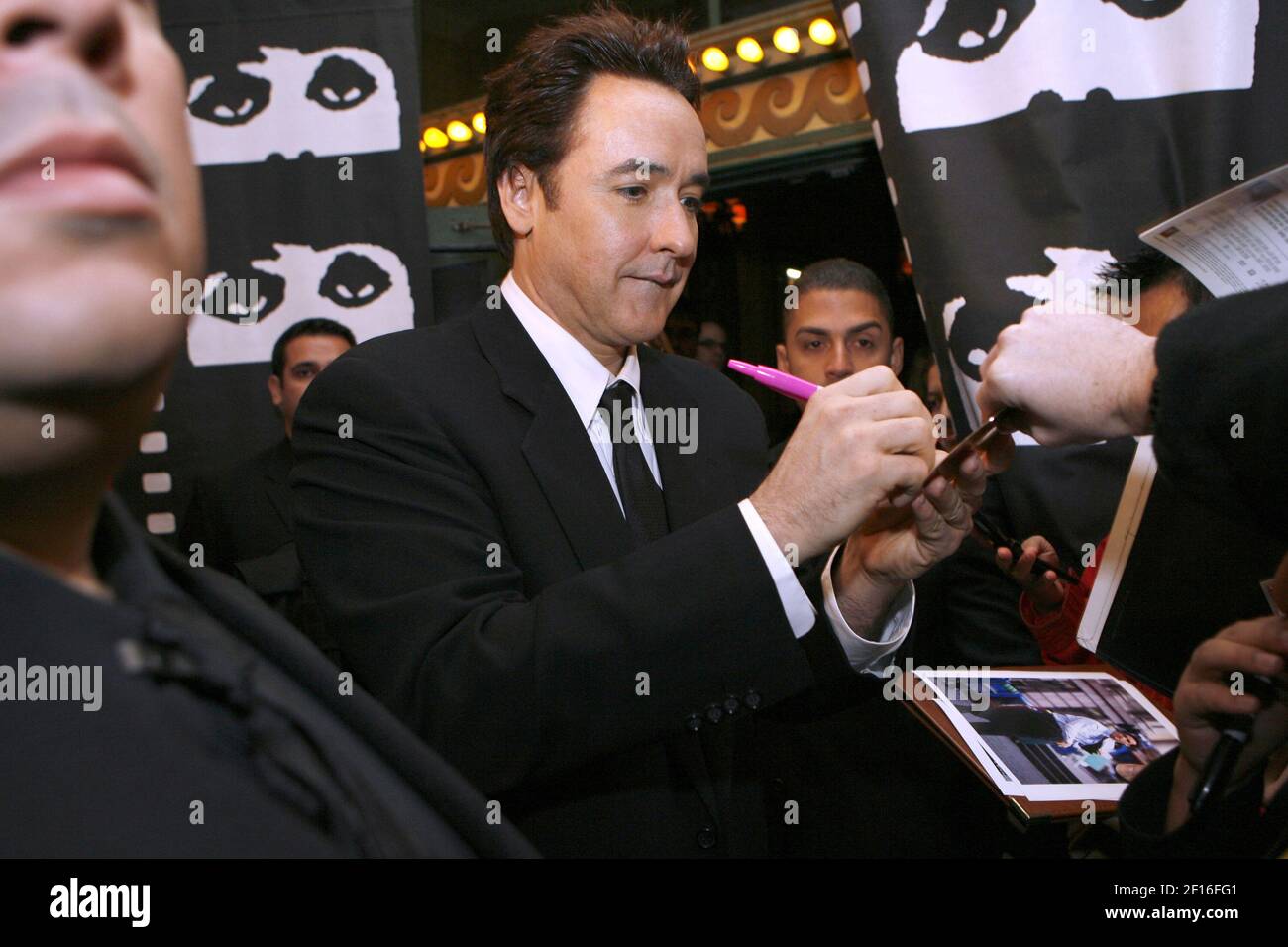 Actor John Cusack signs a few autographs upon arriving at the Music Box ...