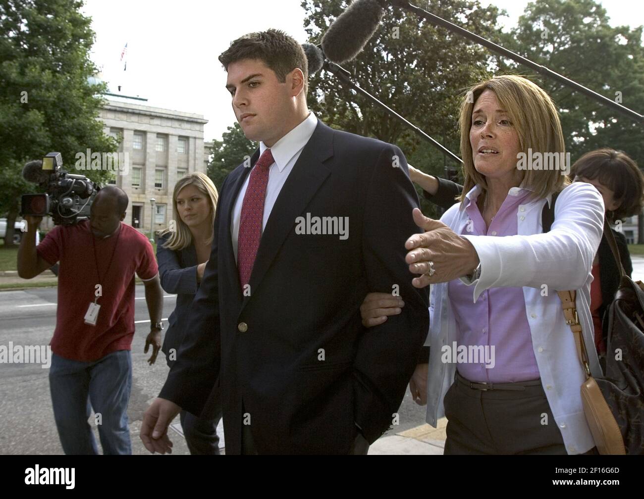 Former Duke lacrosse player Reade Seligmann, left, is guided into court ...