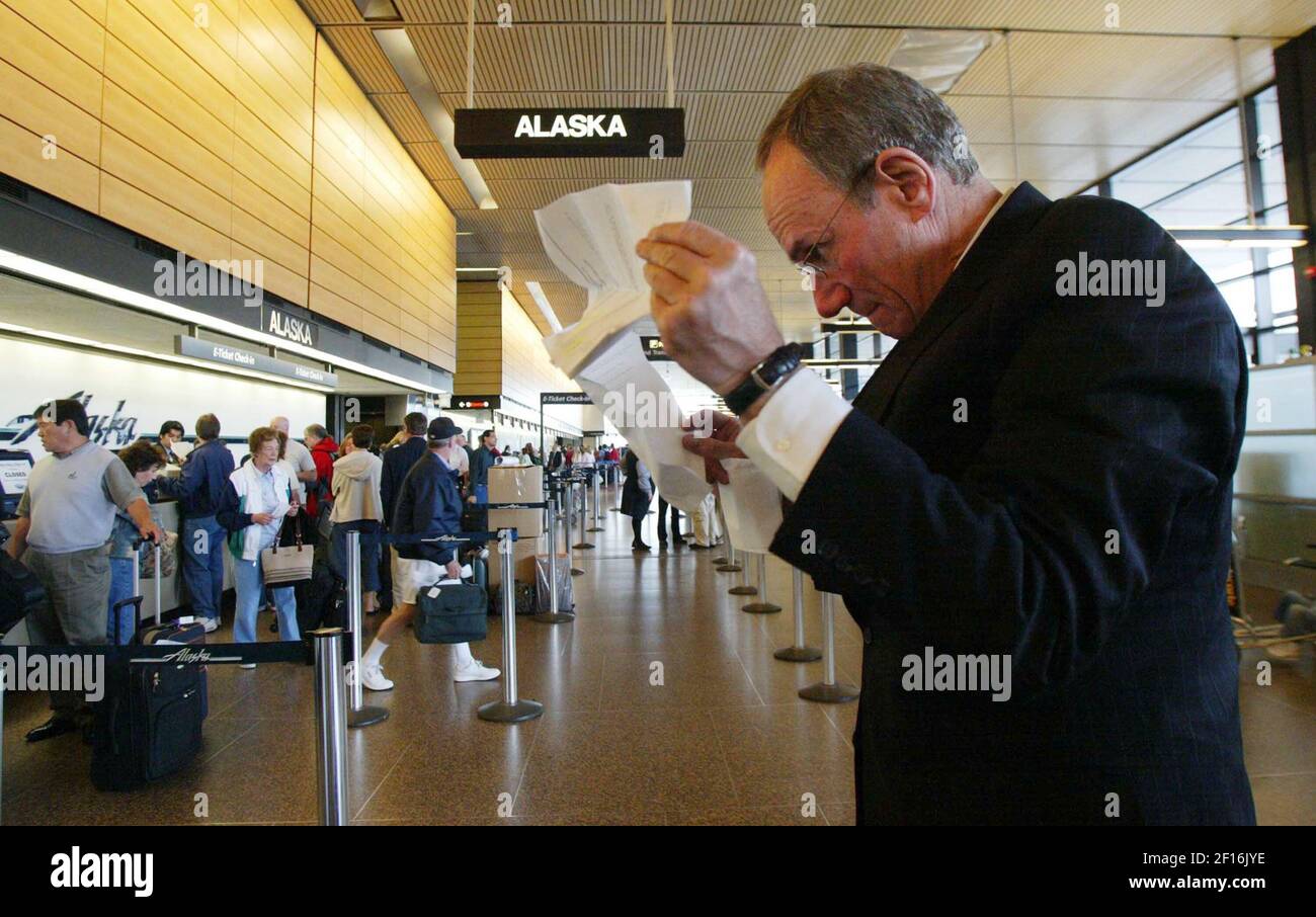 John Miller looks over papers at the airport in Seattle, Washington, in ...