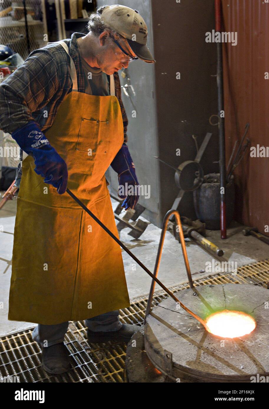 Dan McGuire checks on the progress of silicon bronze that will be ...